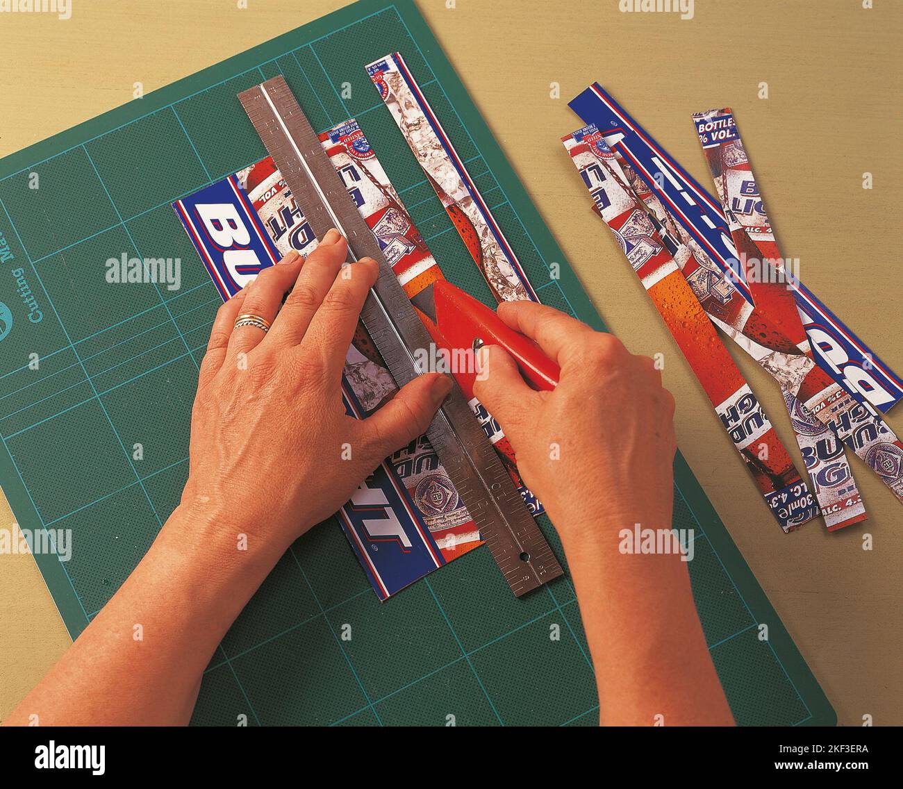 Cutting packagings into strips using mat grid and utility knife Stock ...