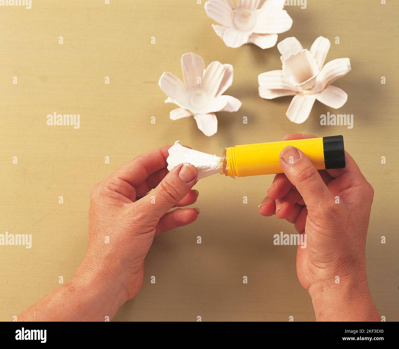 Applying glue to the central part of flower Stock Photo - Alamy