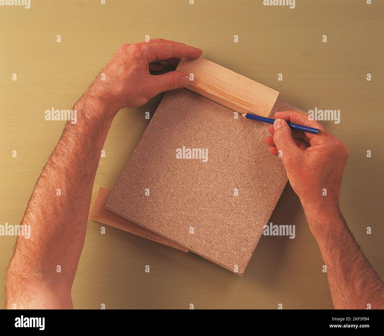 Marking position of a timber piece on the chipboard Stock Photo - Alamy
