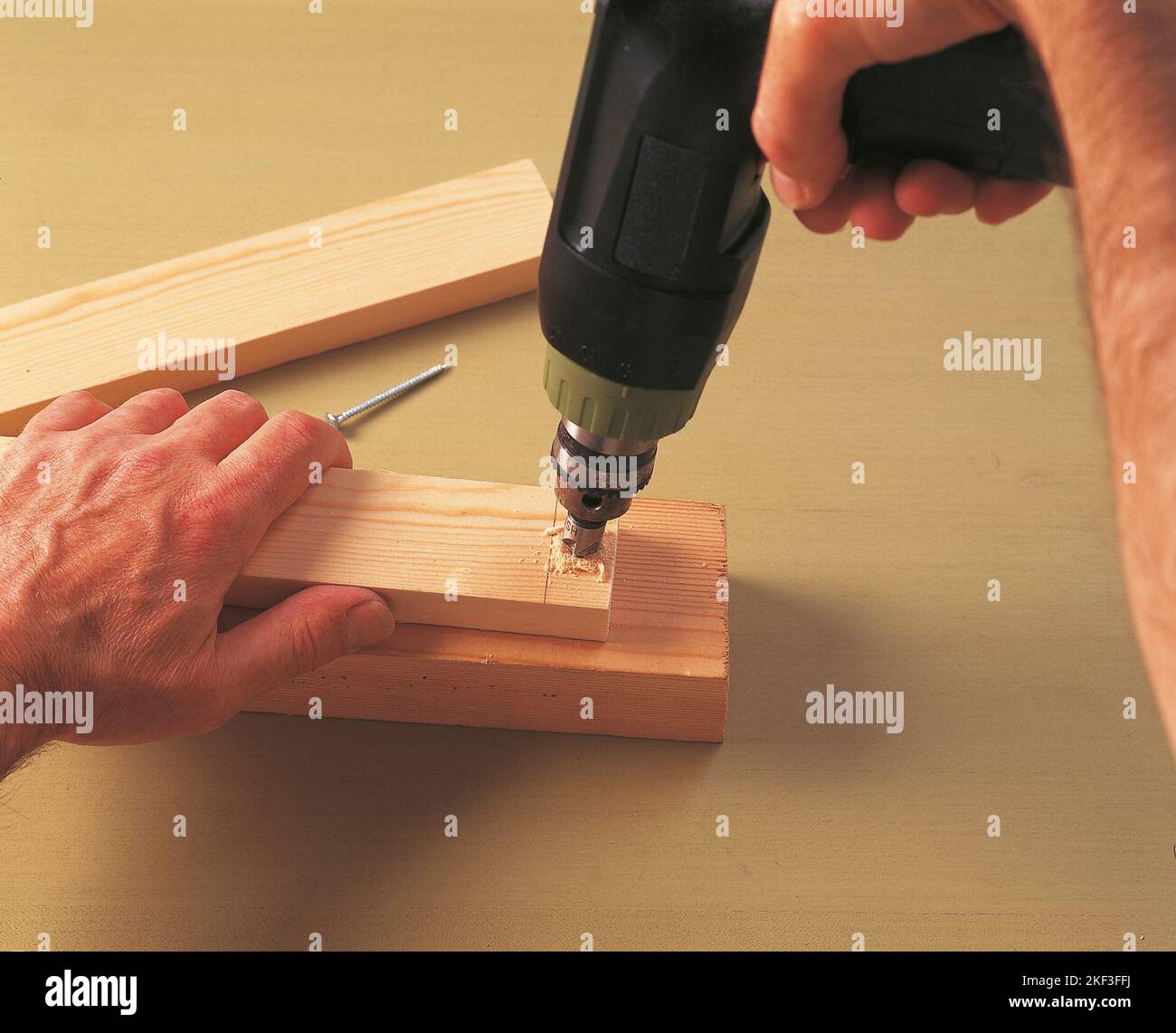 Drilling a hole in a piece of scrap wood Stock Photo - Alamy