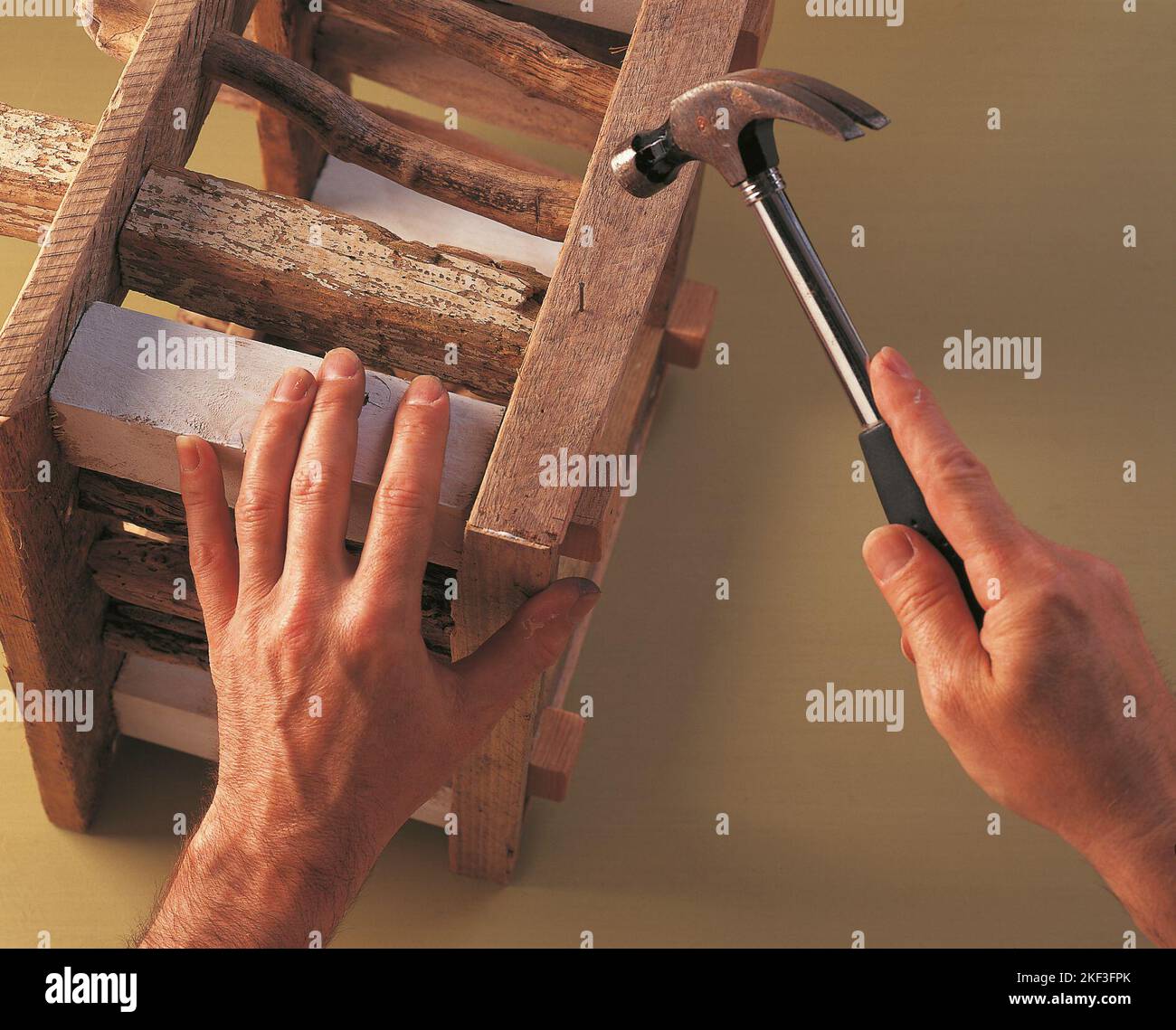 Pinning cladding timber with hammer Stock Photo - Alamy