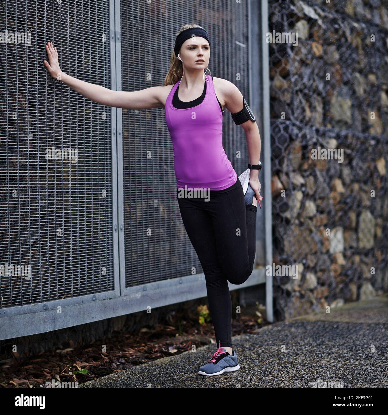 Preparing her muscles for some action. a young woman stretching her ...