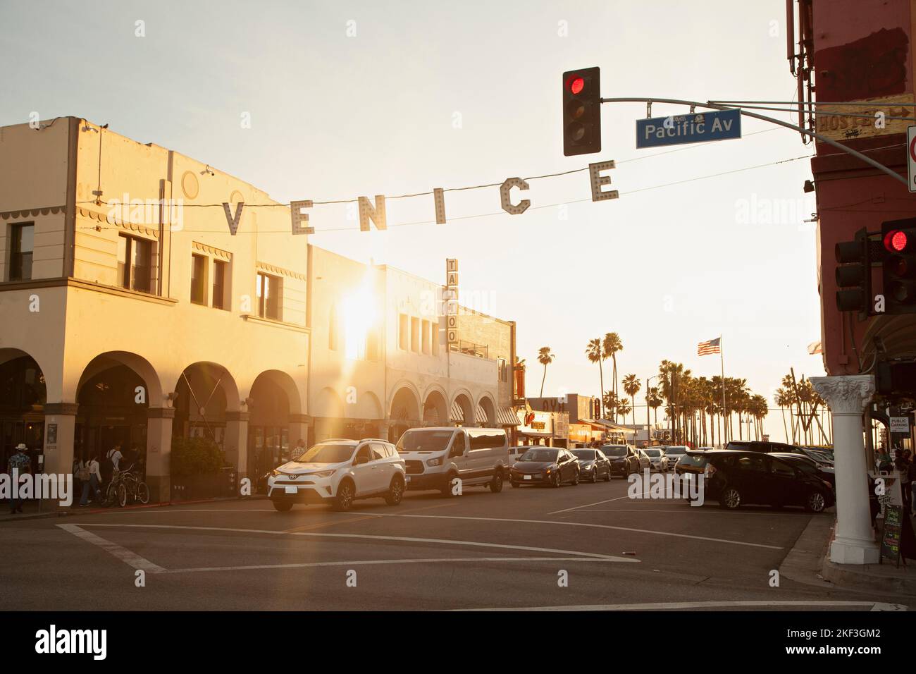 Sign above cars on road during sunset Stock Photo - Alamy