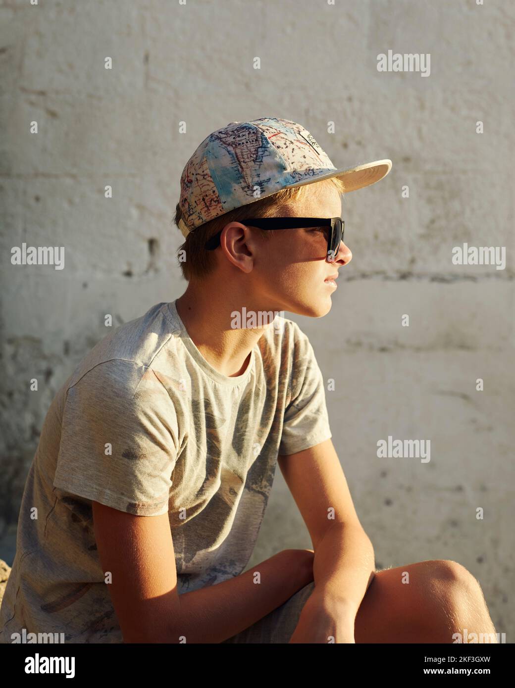 Boy in baseball cap sitting hi-res stock photography and images - Alamy