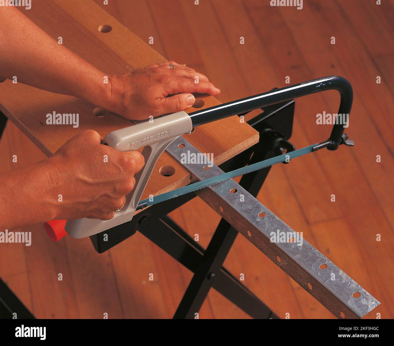 Cutting a steel corner bracket with a hacksaw Stock Photo - Alamy