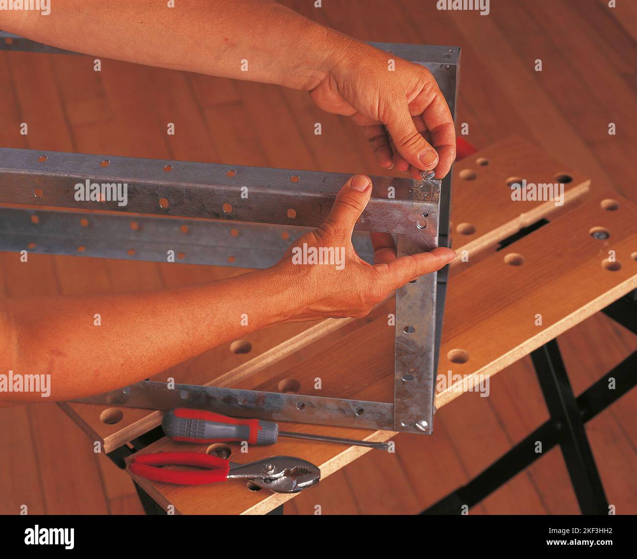 Securing the brackets together with a screw Stock Photo - Alamy
