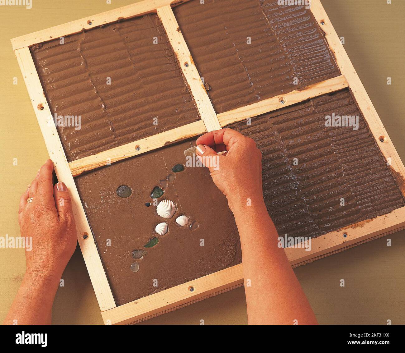 Pressing a decorative piece into the wet concrete Stock Photo - Alamy