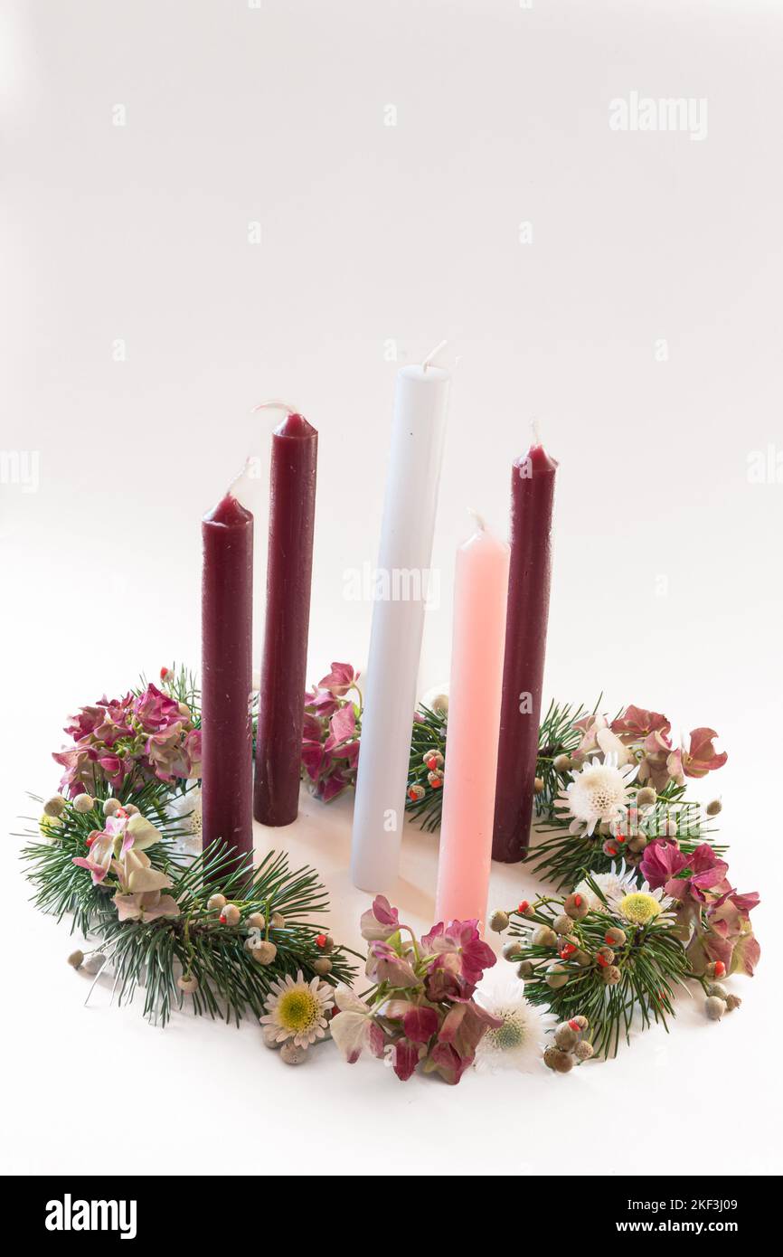 3 purple candles, 1 pink and one white candle on decorated and adorned ...