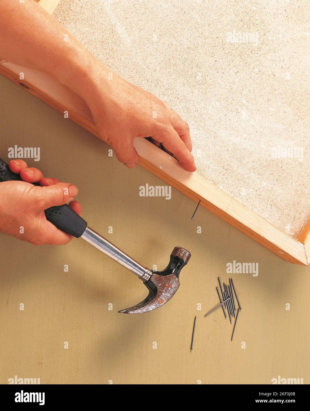 Pinning a timber frame with a hammer Stock Photo - Alamy
