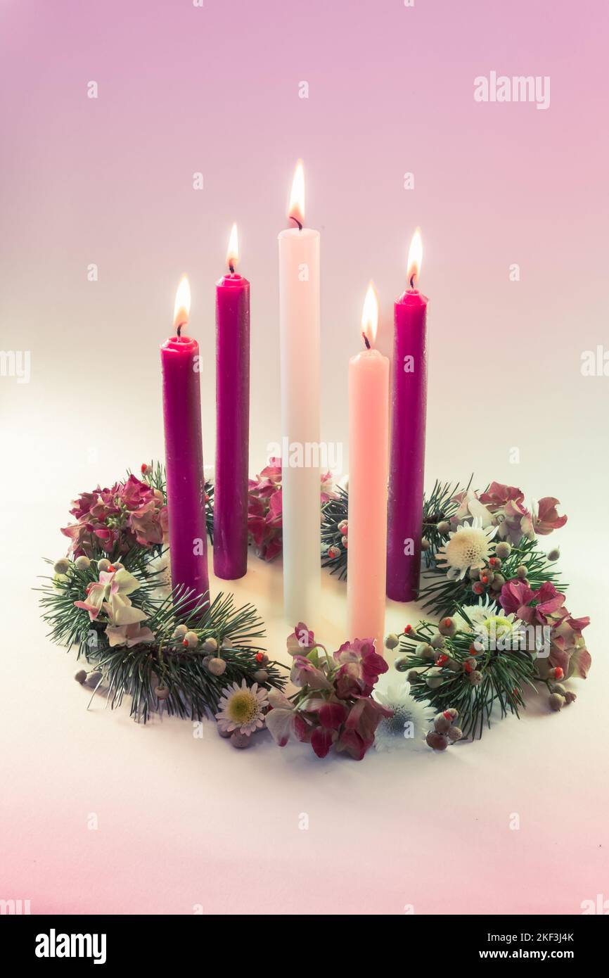 3 purple candles, 1 pink and one white candle on decorated and adorned ...