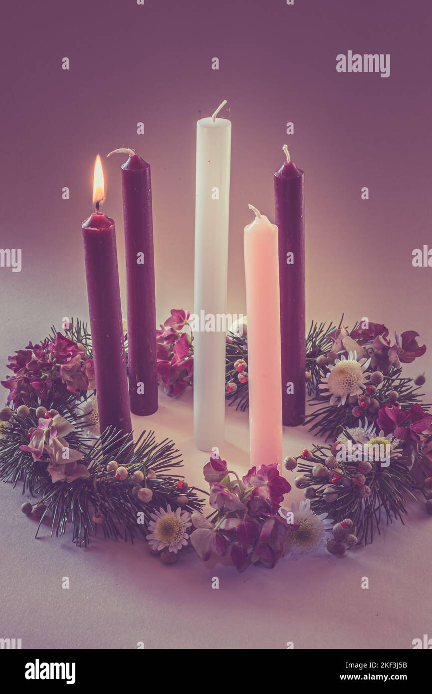 3 purple candles, 1 pink and one white candle on decorated and adorned ...