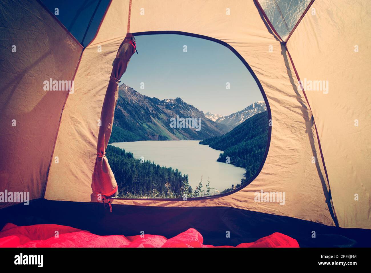 View of the beautiful mountain lake from the open tent. The concept of ...