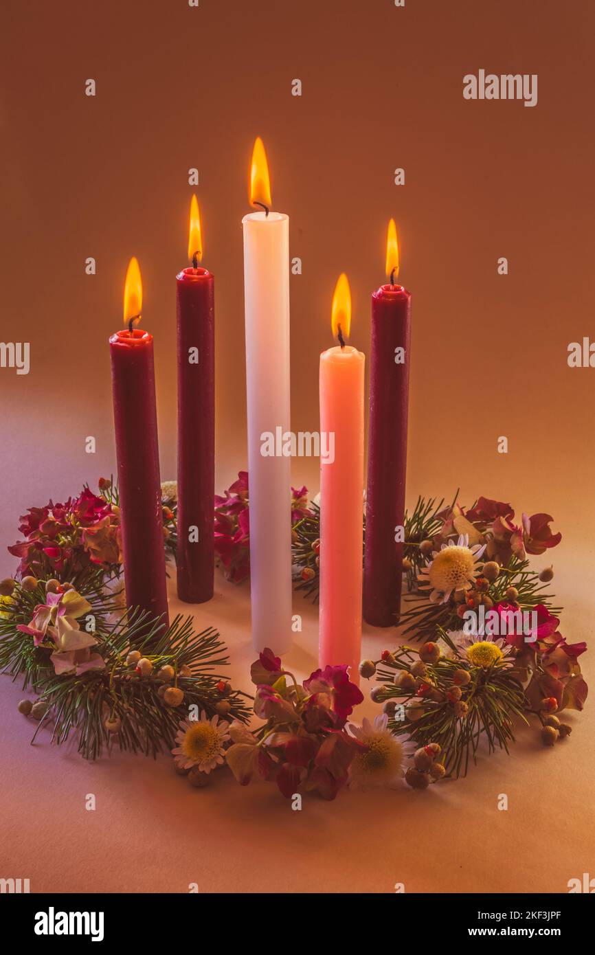 3 purple candles, 1 pink and one white candle on decorated and adorned ...