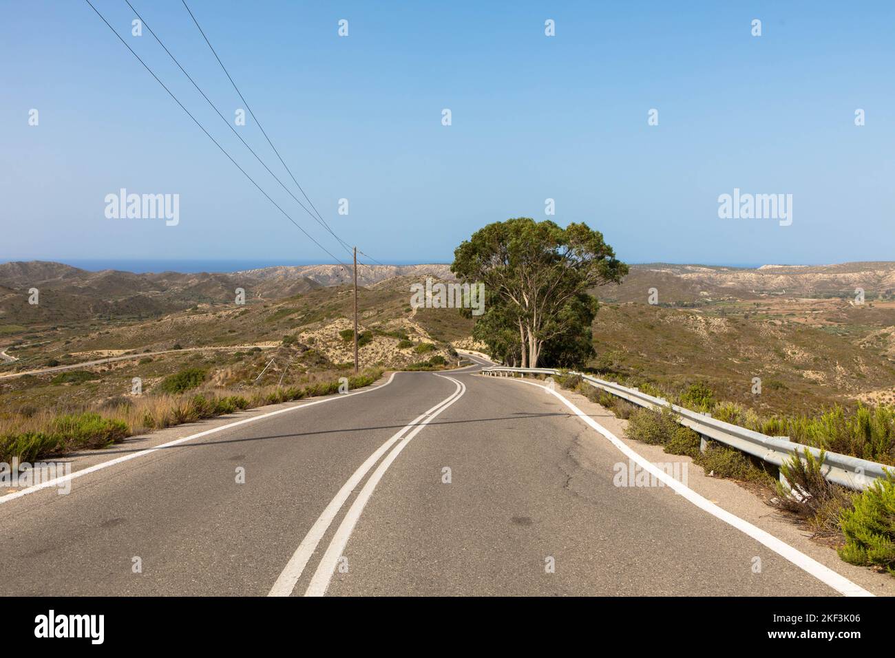 Country road through the typical Greek Mediterranean landscape with ...