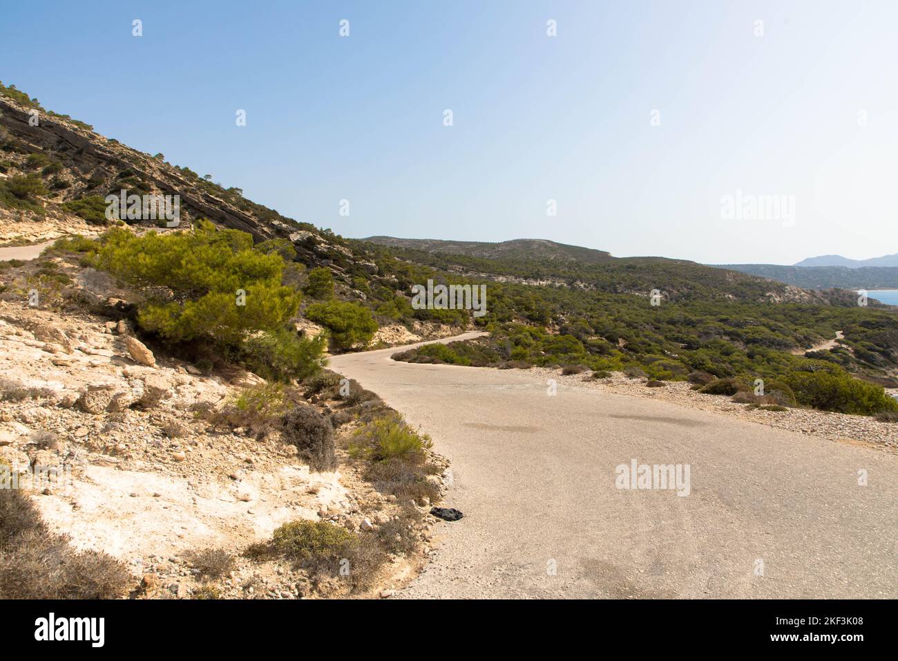 Country road through the typical Greek Mediterranean landscape with ...