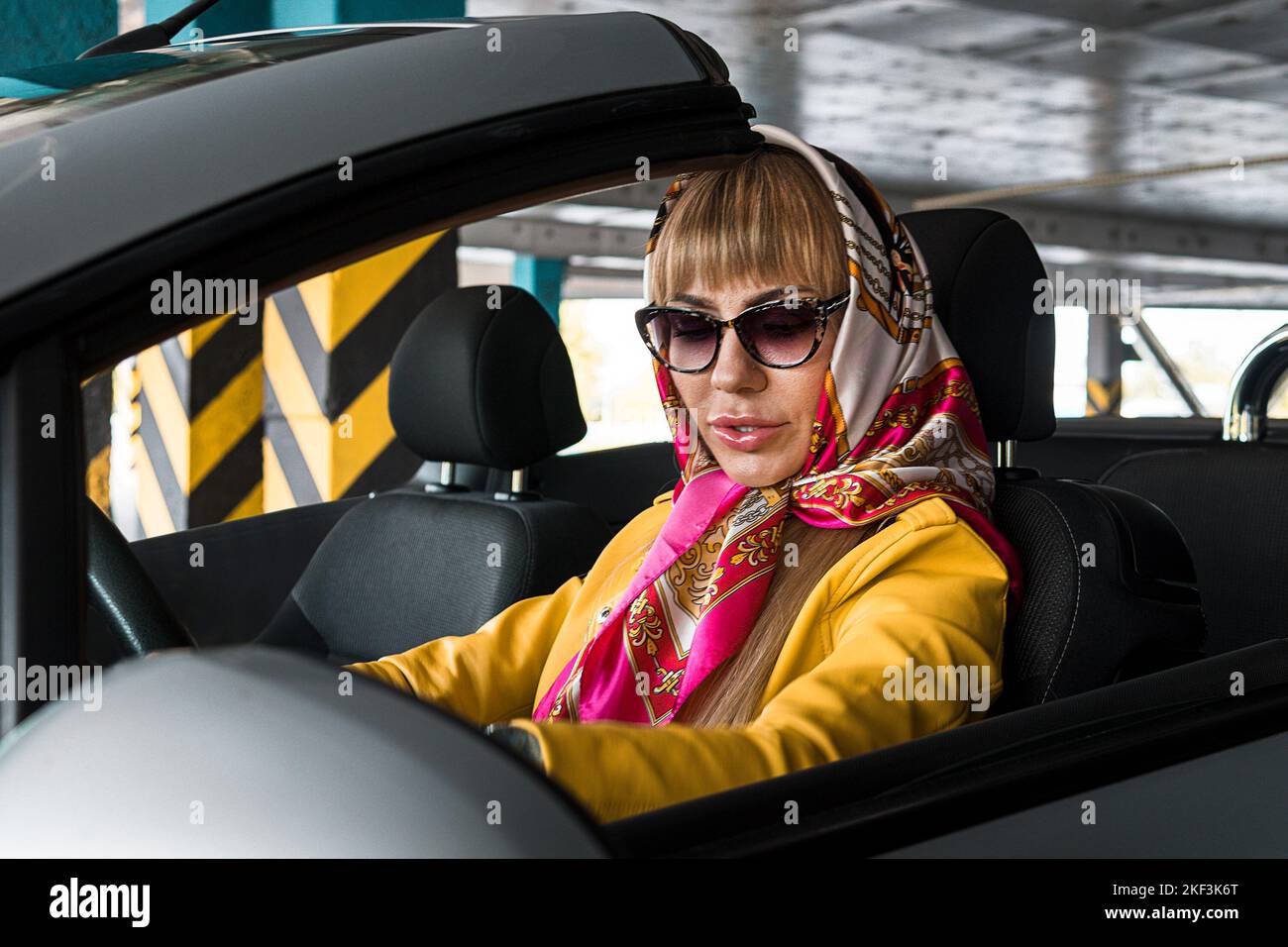 Young woman looking in the car rear view mirror Stock Photo - Alamy