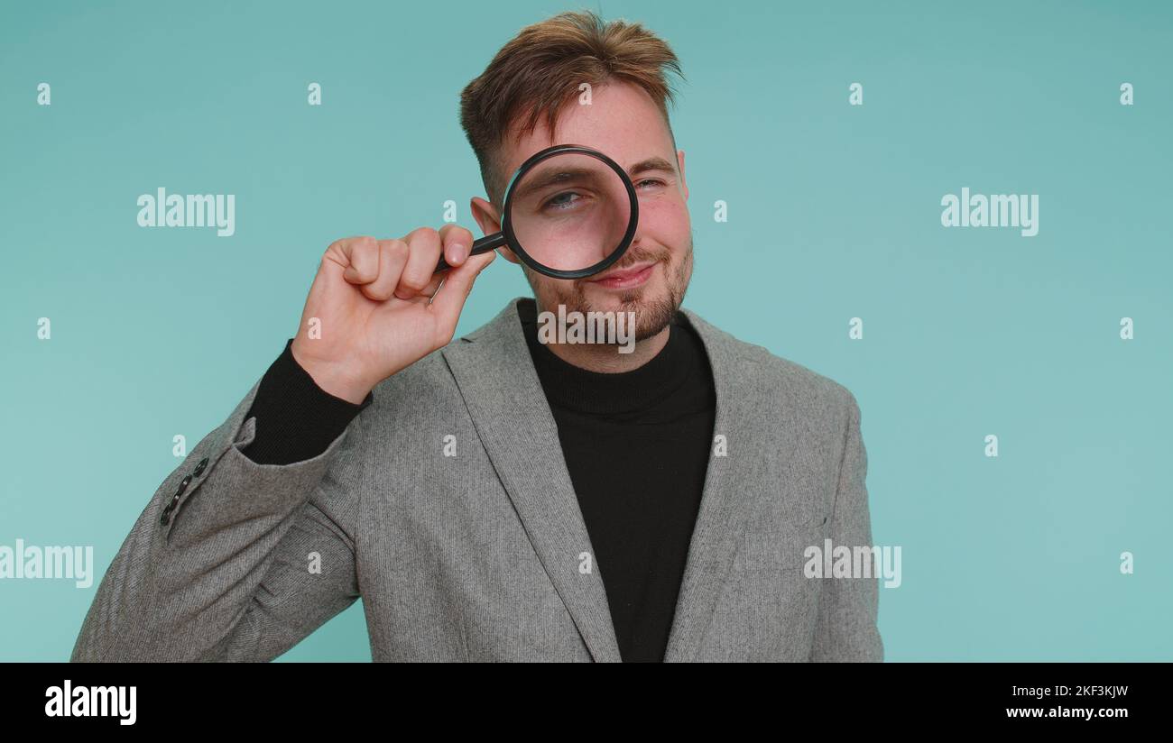 Investigator researcher scientist business man holding magnifying glass ...