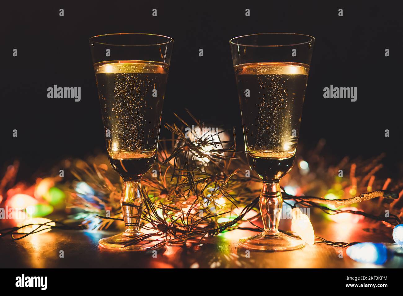 Two champagne glasses and Christmas ornaments. Romantic evening with ...