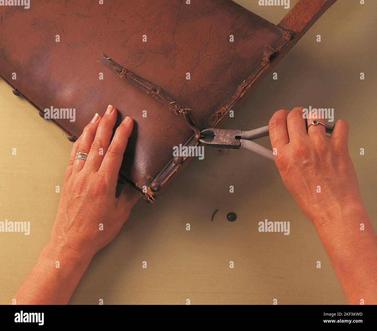 Removing a damaged upholstery material Stock Photo - Alamy