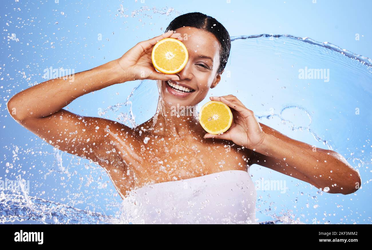 Woman, beauty and fruit with water splash in skincare hydration against ...