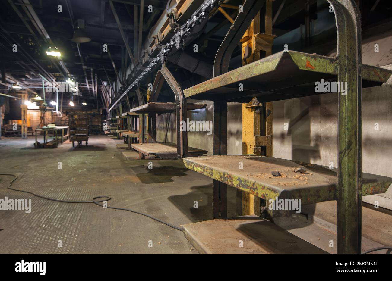 An empty load sling at an overhead conveyor in an old factory Stock ...