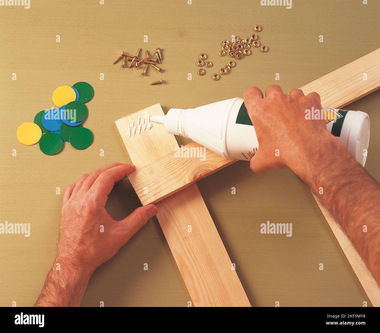 Applying glue on a piece of timber Stock Photo - Alamy