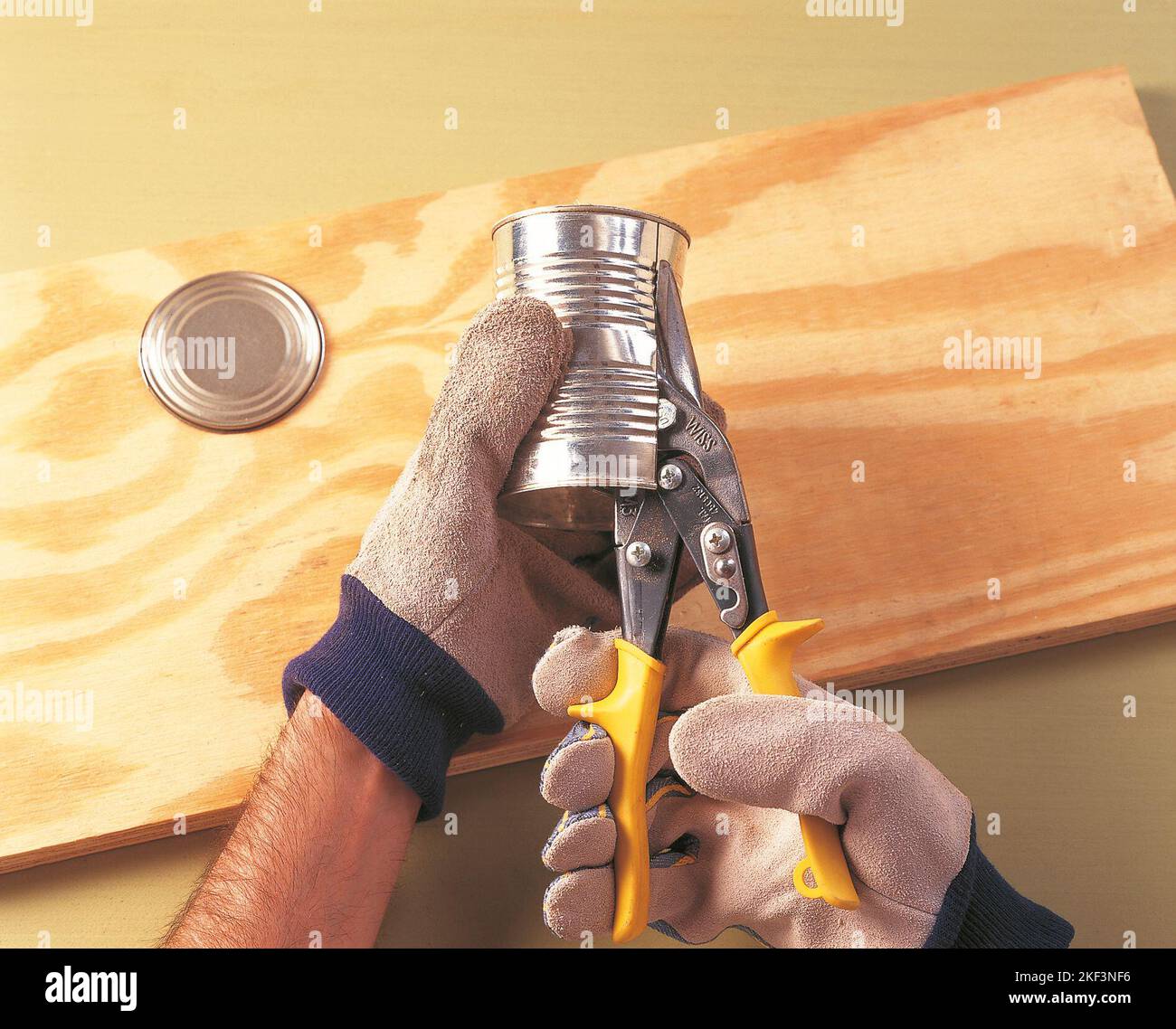 Cutting a metal can with a pair of tin shears Stock Photo - Alamy