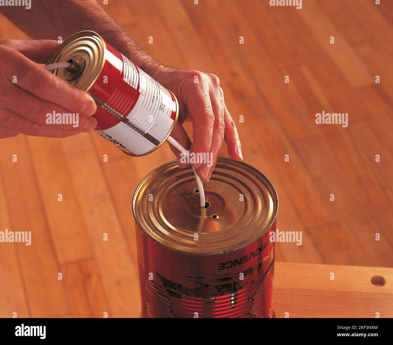 Feeding a cable through a hole Stock Photo - Alamy