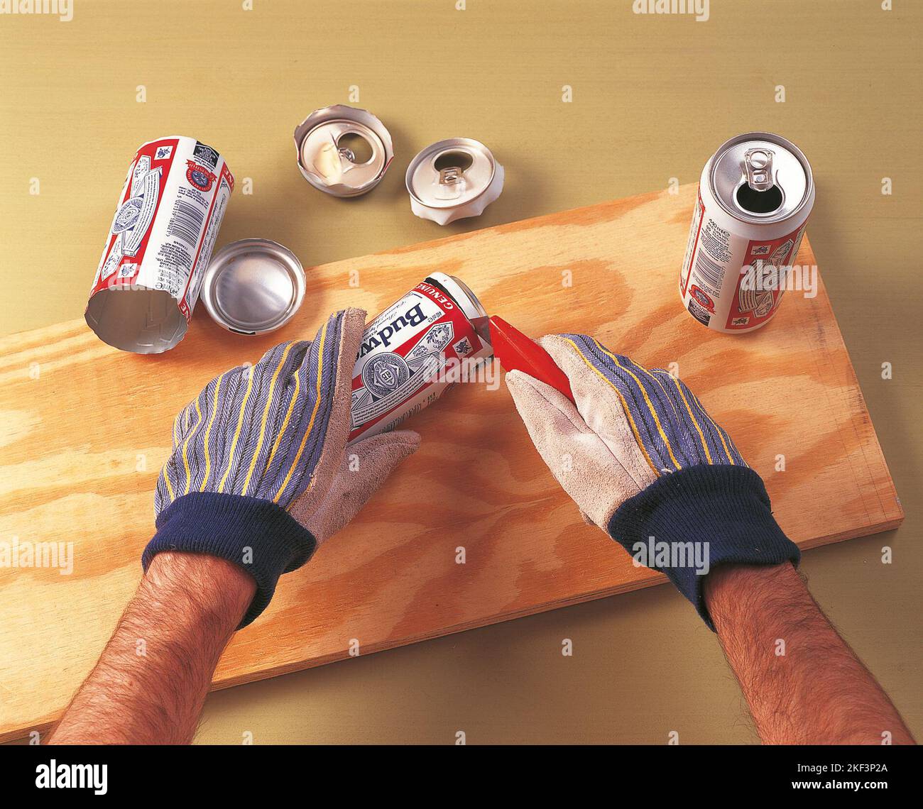 Cutting off an end of a beer can with a craft knife Stock Photo - Alamy