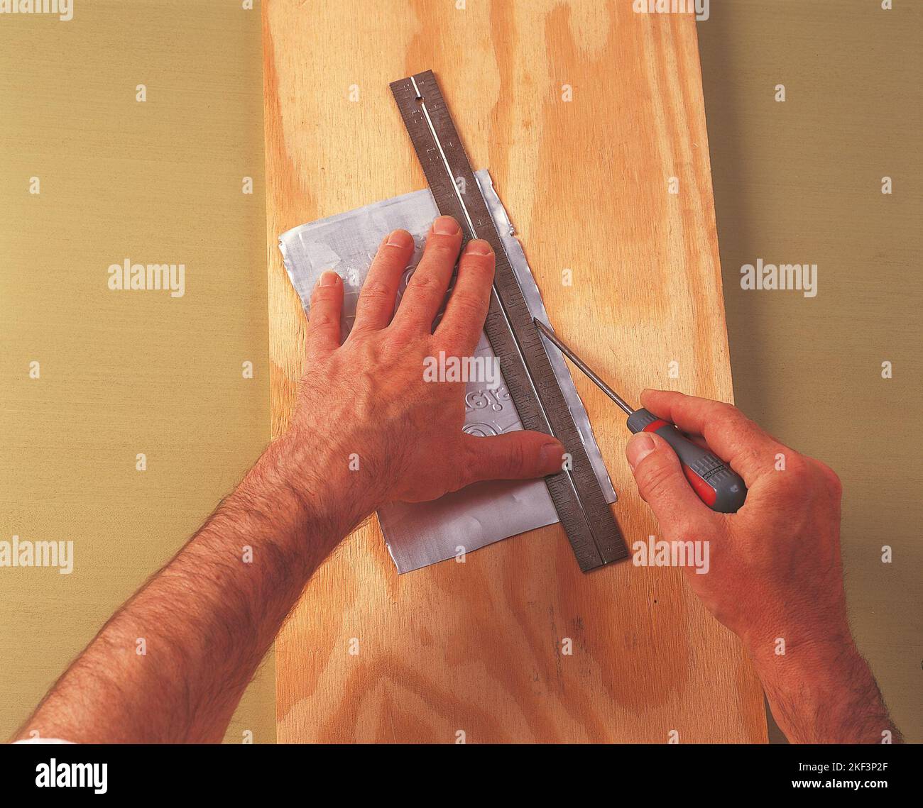 Drawing an indented line with a screwdriver Stock Photo - Alamy