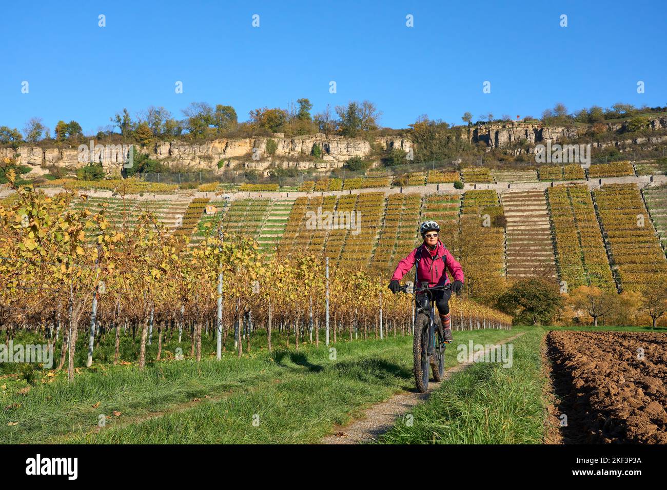 nice senior woman riding her electric mountain bike in the steep ...