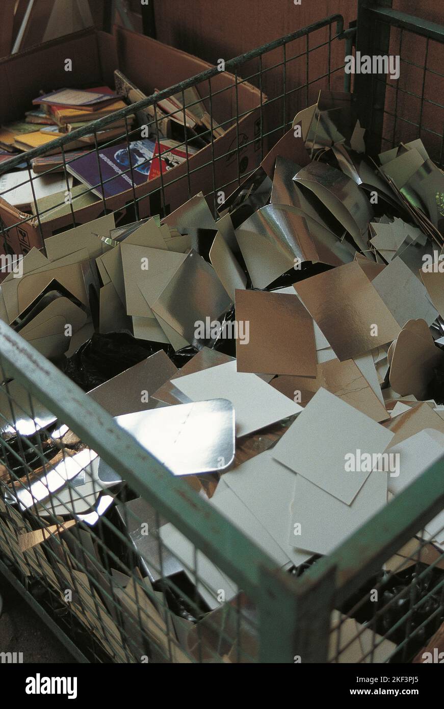 Large amount of paper sheets in metal containers Stock Photo - Alamy