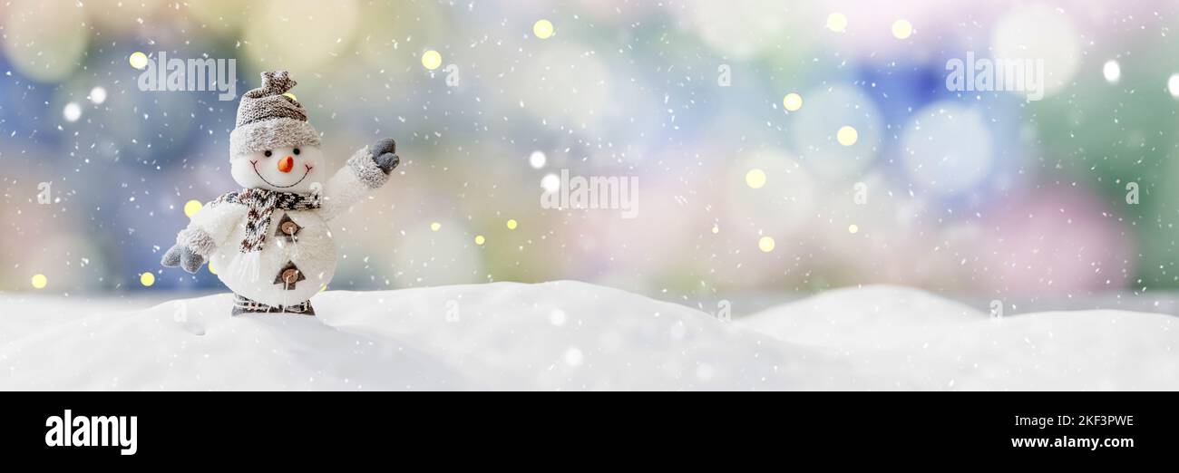 Snowman waving in snow fall, winter background, wide panorama ...