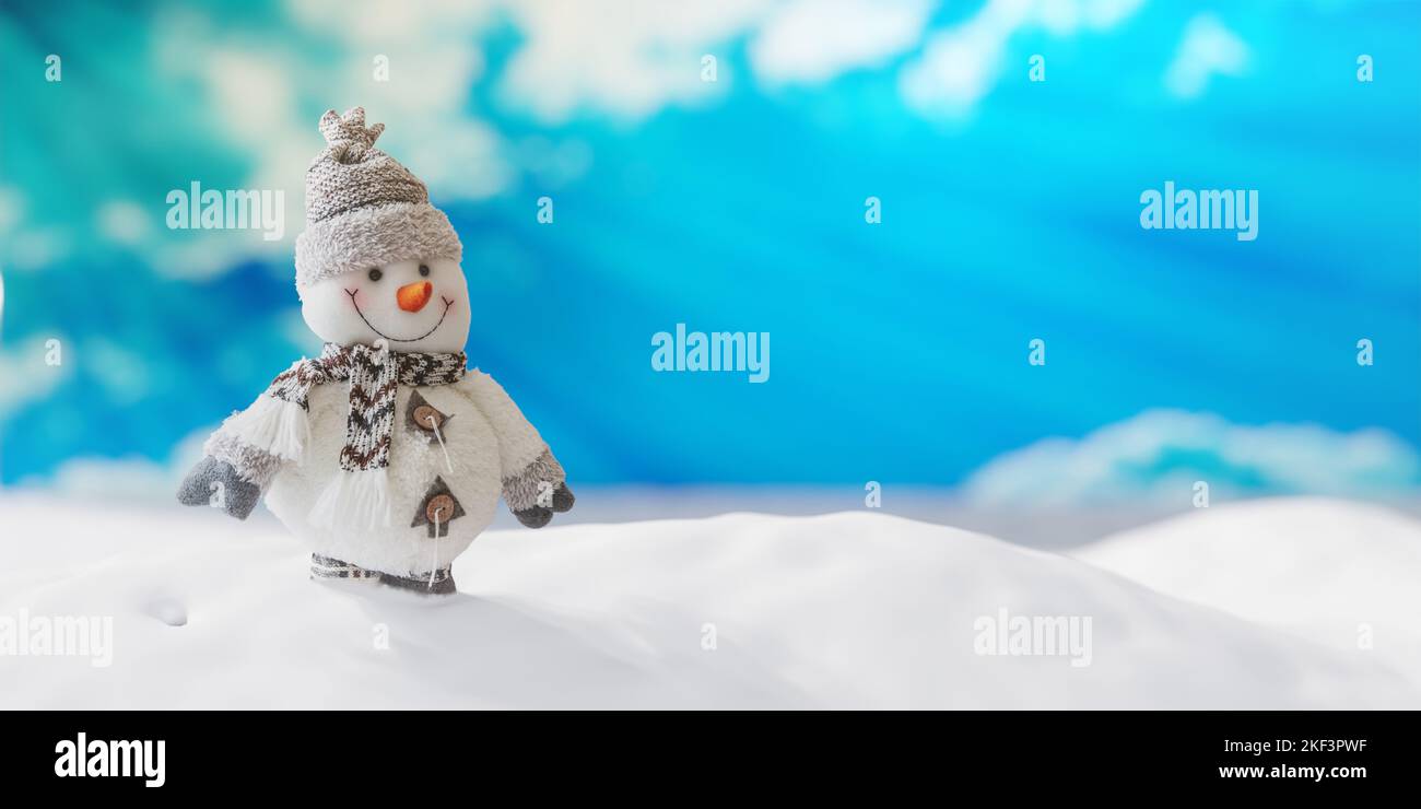Snowman on snow, blue sky and winter snowy background, copy space ...