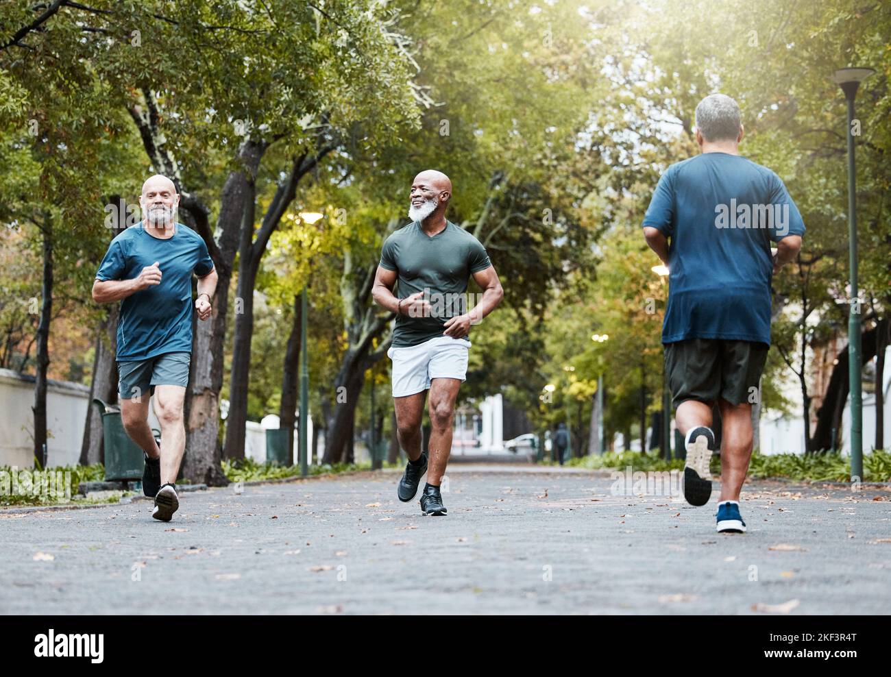 Fitness, health and senior men running in nature on garden path with ...