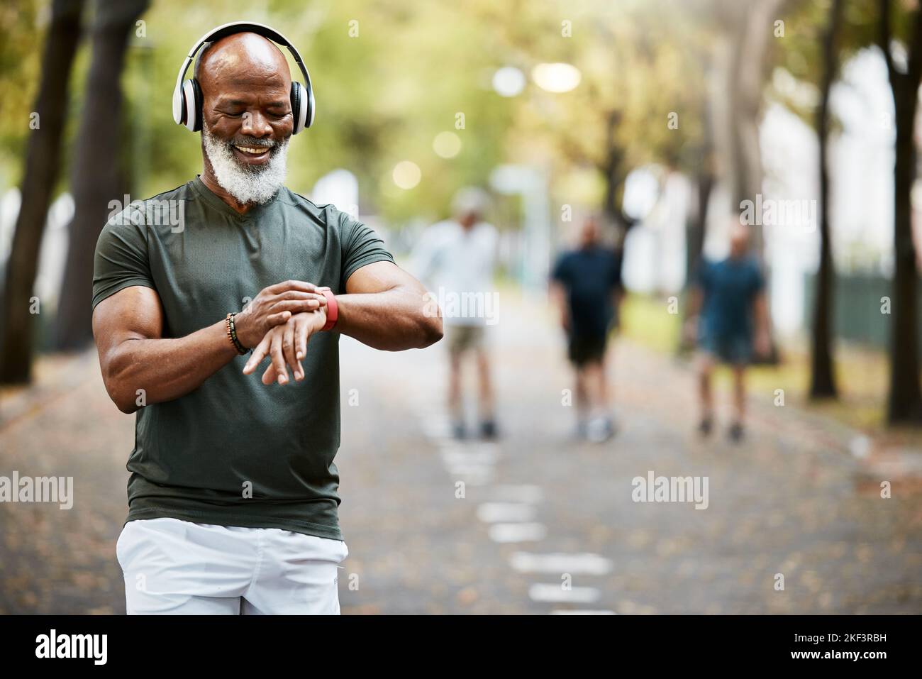 Music, time and running with a mature black man looking at his watch ...