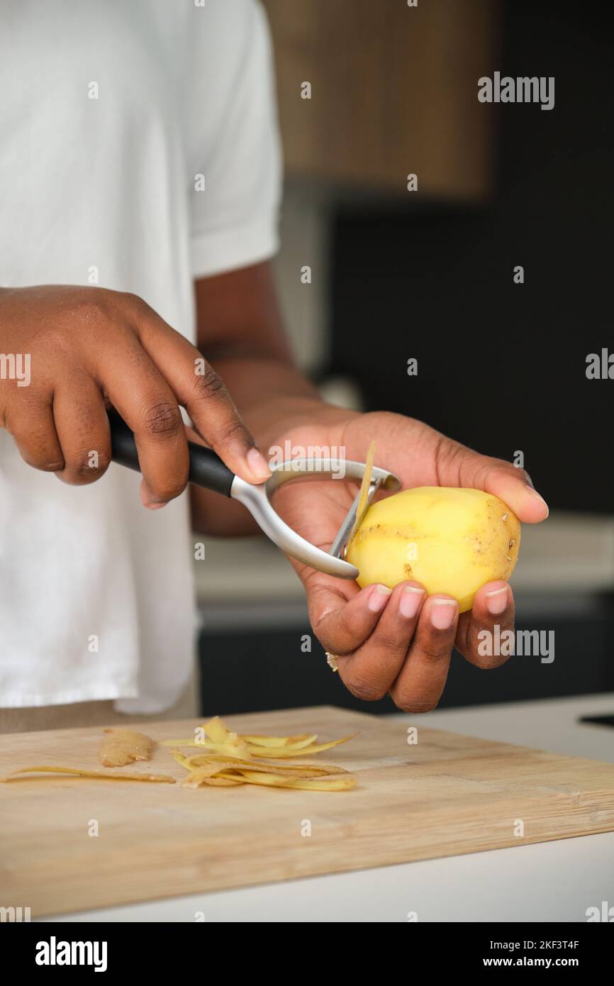 Close up of cuban woman hands peeling a raw potato Stock Photo - Alamy