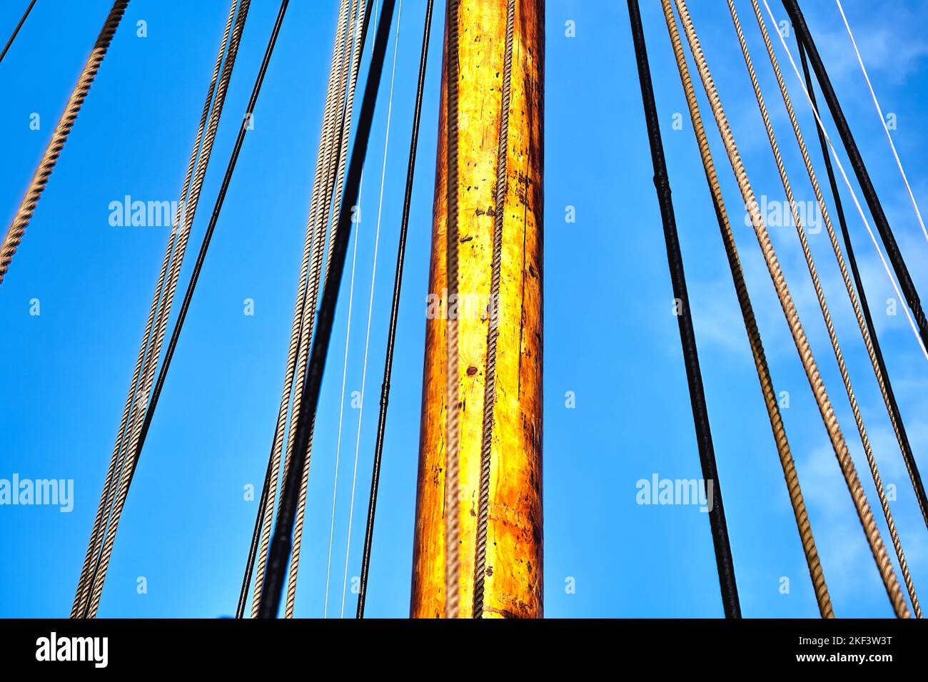 Mast of a sailing ship to which ropes and cables rise at an acute angle ...