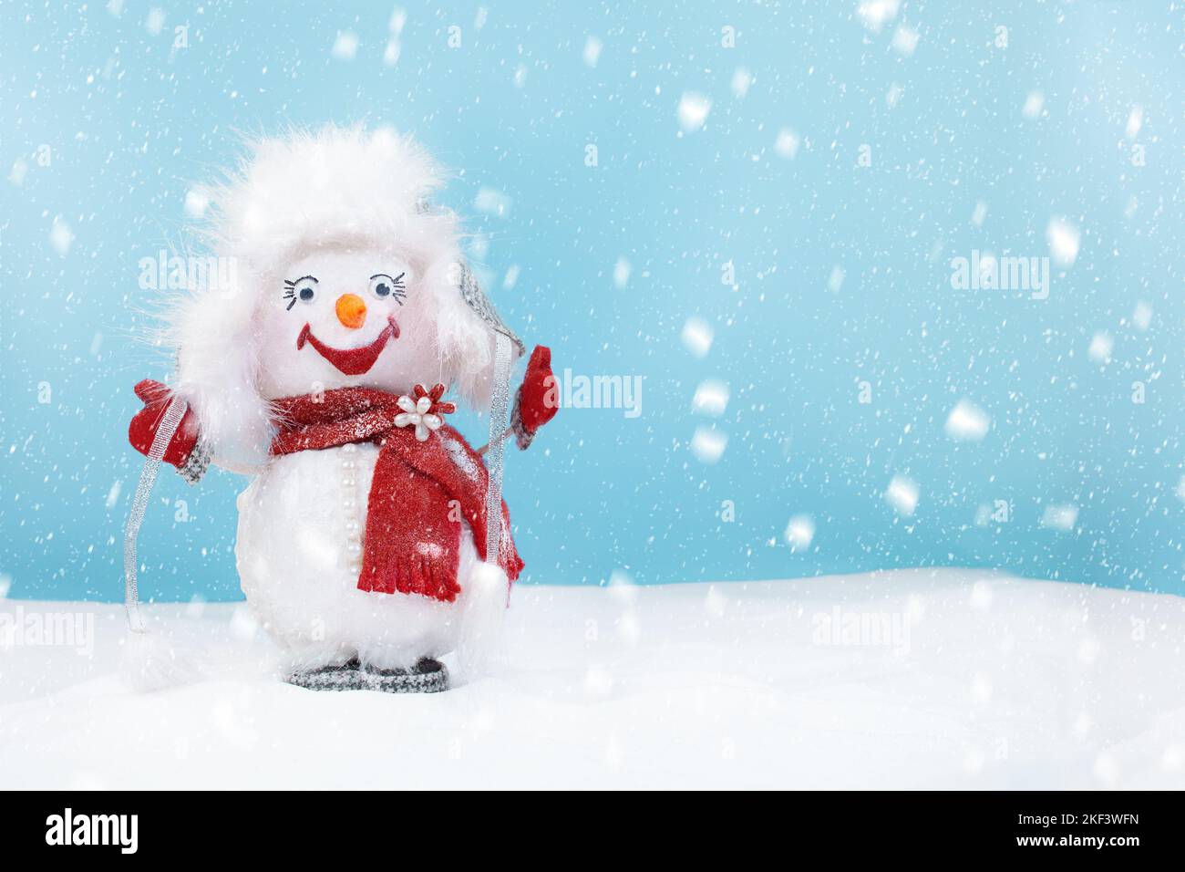 Cute happy snowman wearing fluffy hat and red scarf standing in the ...