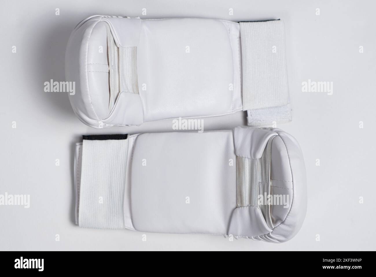 White boxing gloves for a child to practice karate or other martial ...