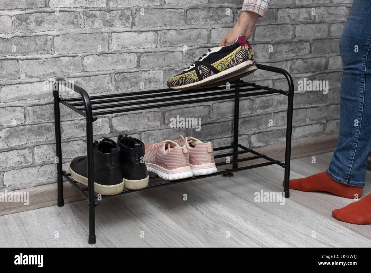 girl puts on sneakers after returning from a walk. man putting on shoes ...