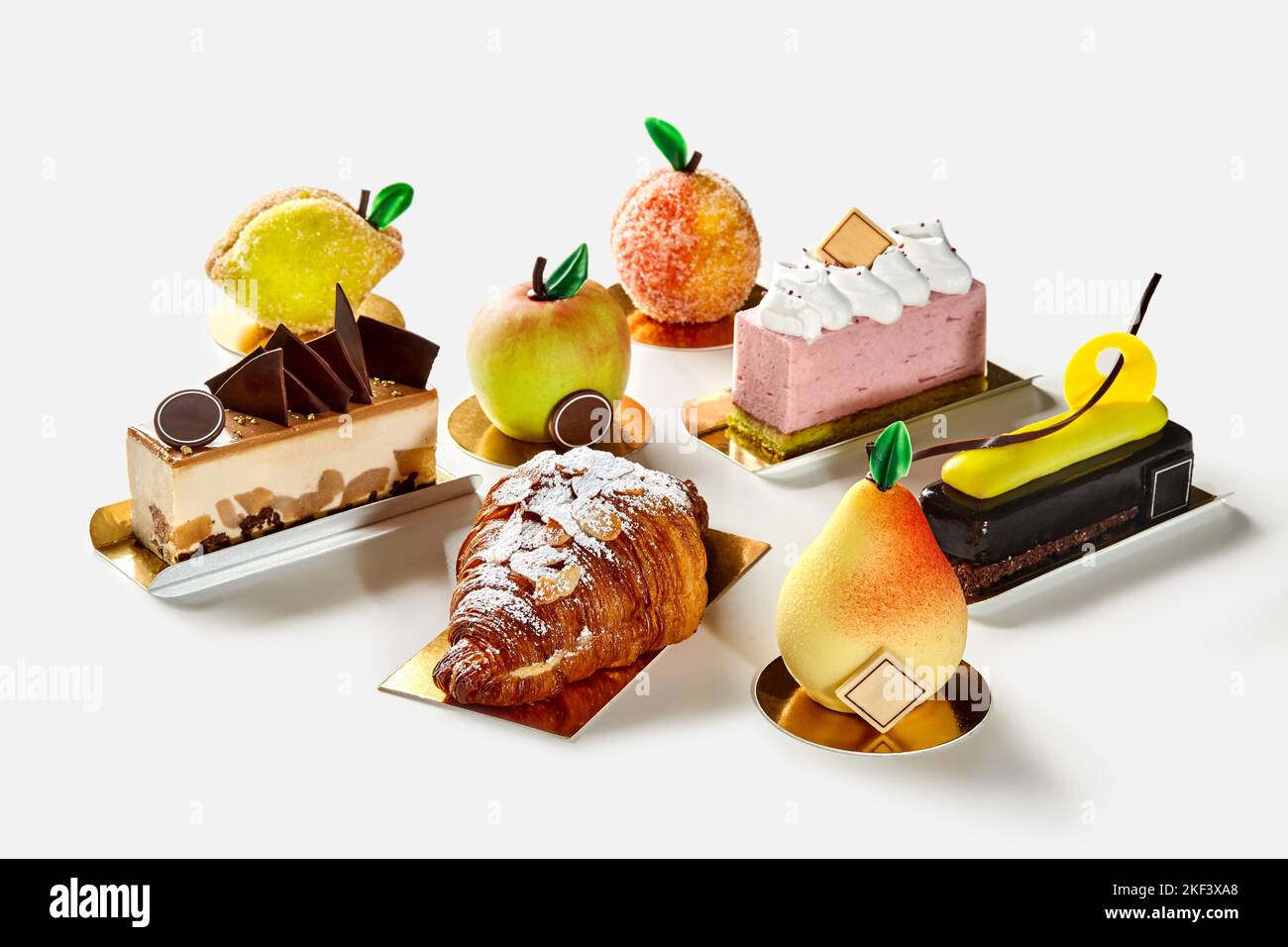 Baked fruit shaped pastries, mousse and chocolate cake slices, puff ...