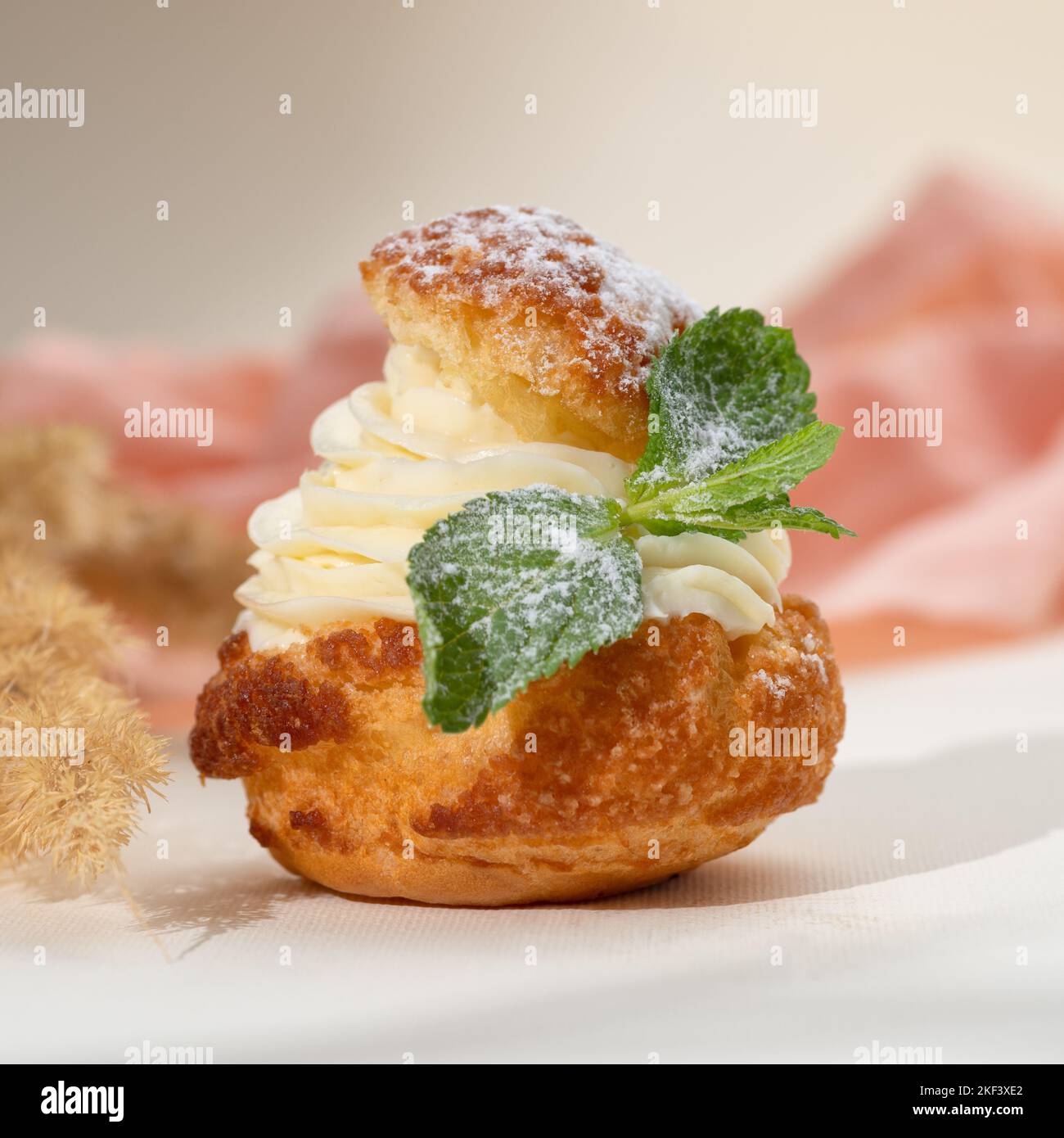 French dessert choux a la creme with whipped cream and mint. Shu cake ...