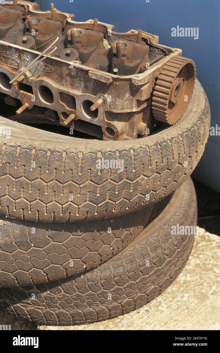 A metal car part and old wheel tyres Stock Photo - Alamy
