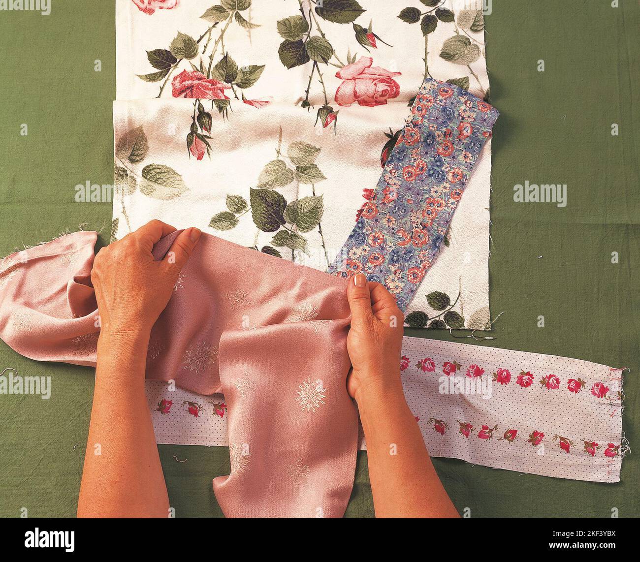 Holding a piece of fabric Stock Photo - Alamy