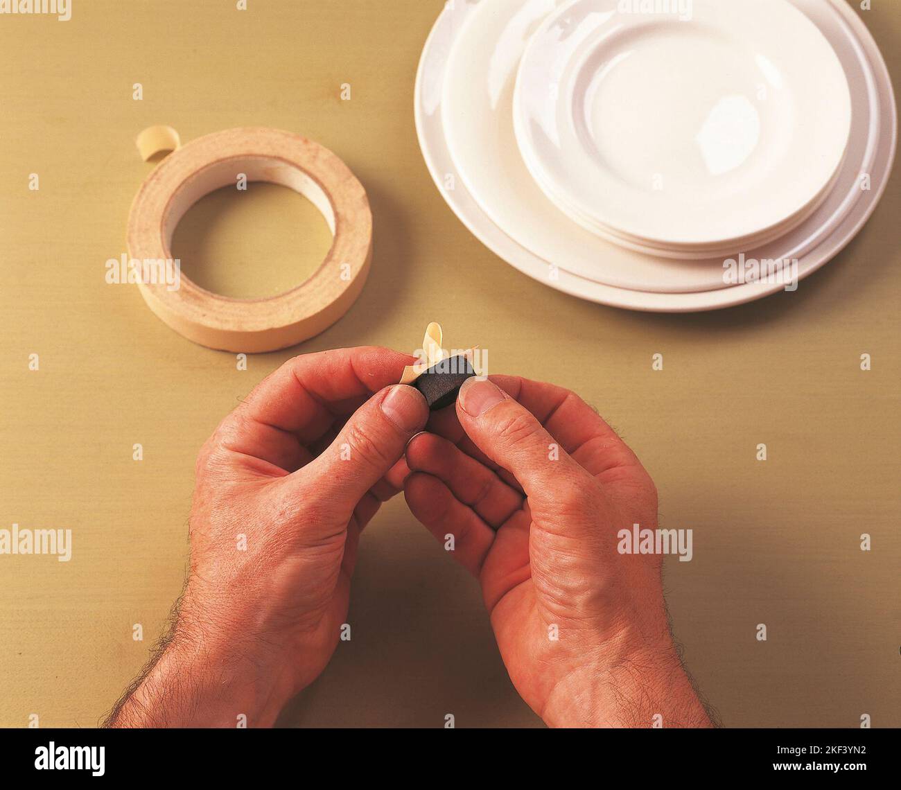Attaching a piece of tape to the circle to form a stamp Stock Photo - Alamy