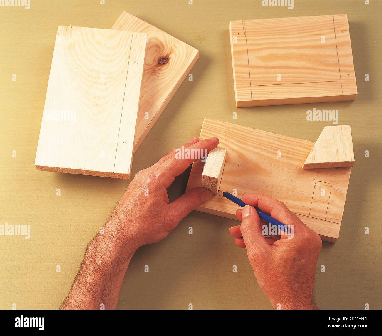 Drawing a line on a piece of scrap timber Stock Photo - Alamy