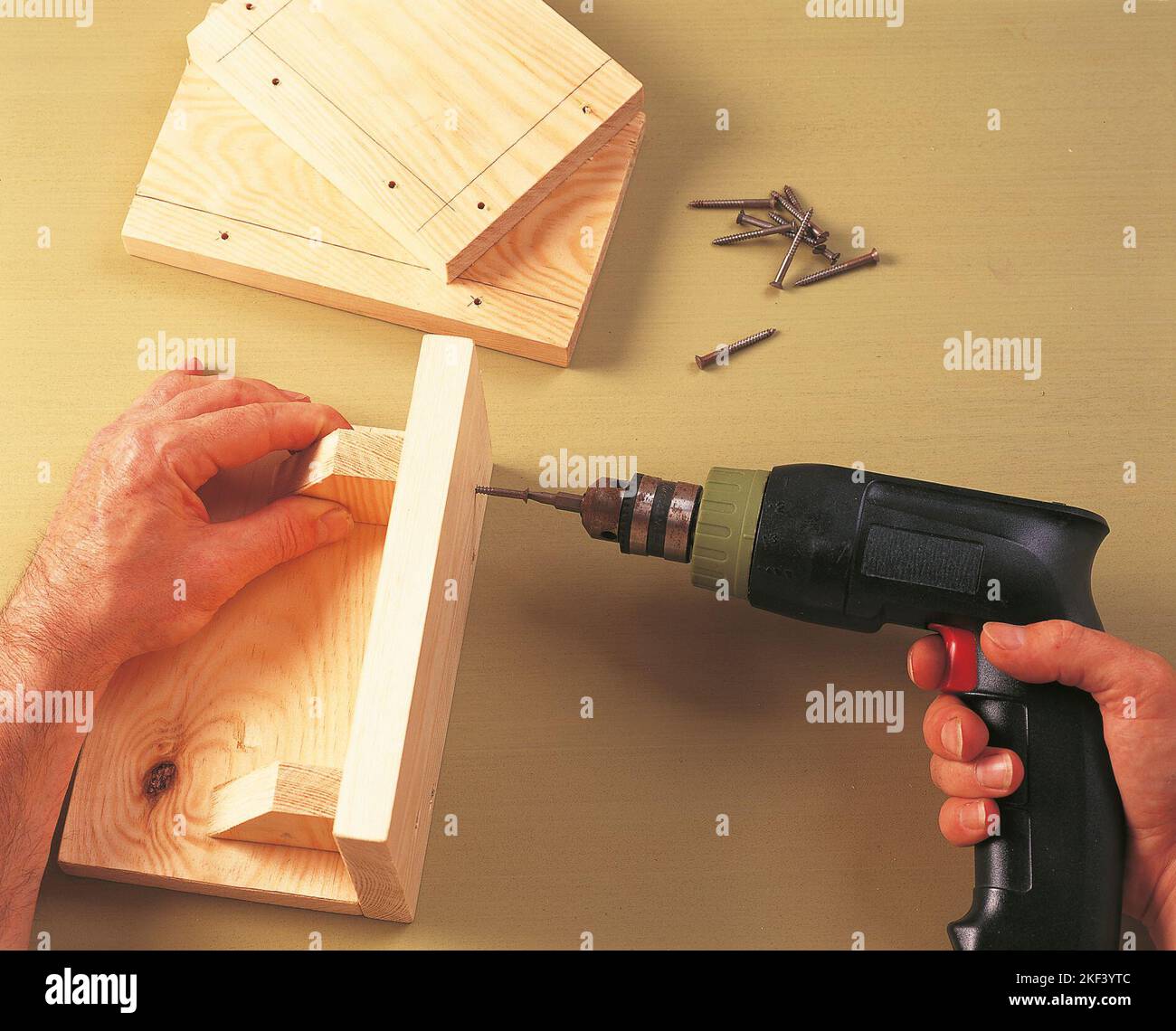 Drilling a hole in the base of the wooden structure Stock Photo - Alamy