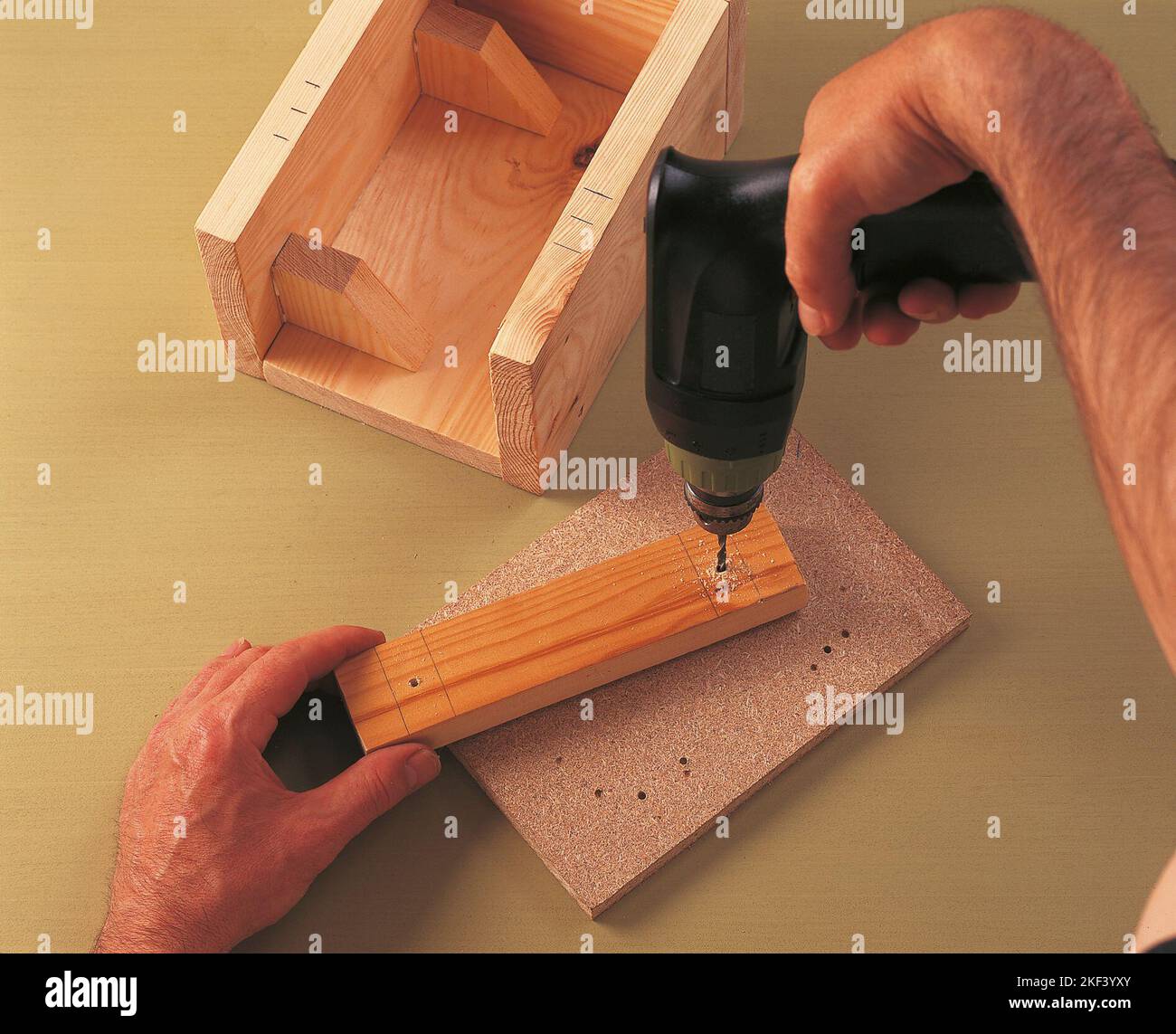 Drilling a hole in the rectangular piece of wood Stock Photo - Alamy