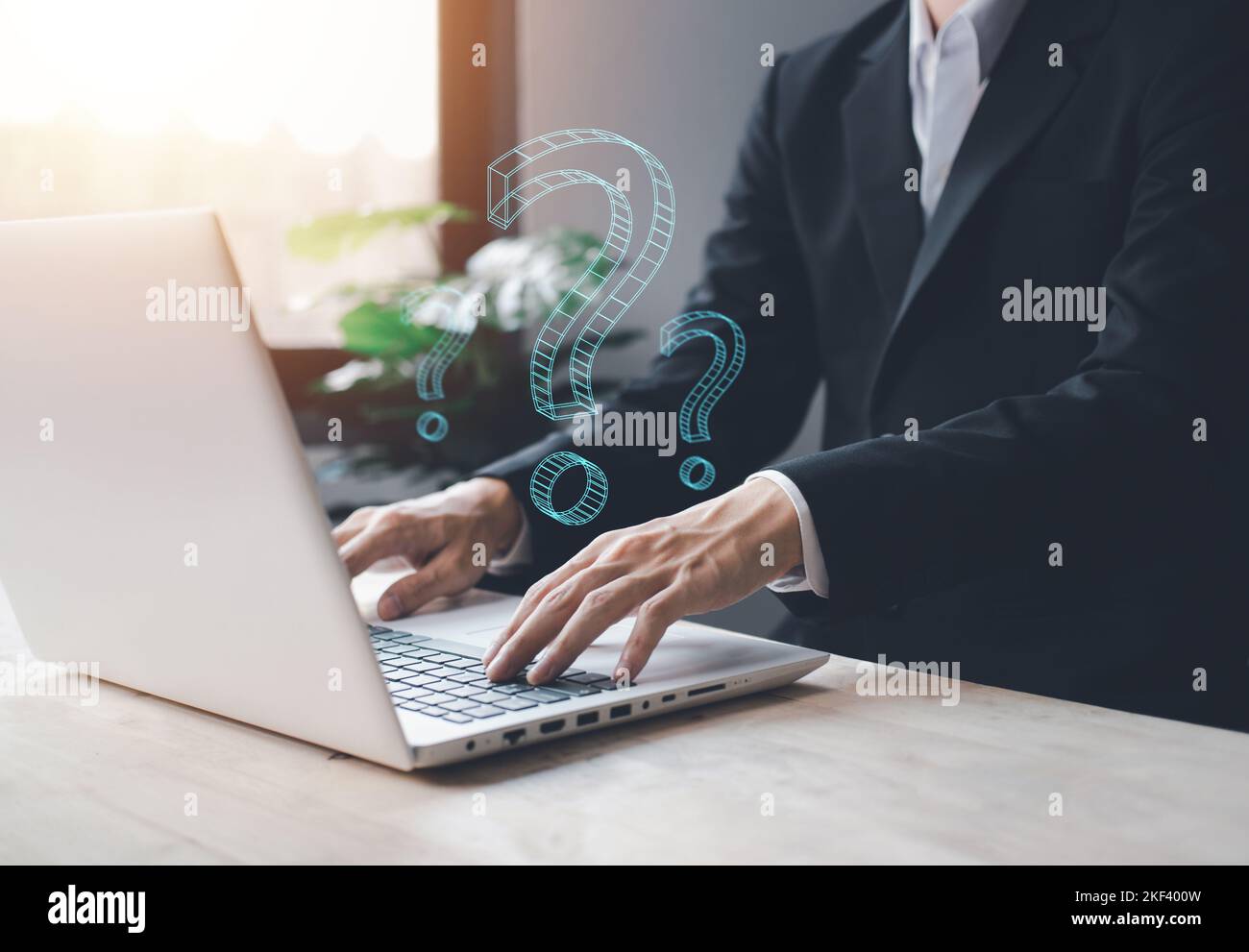 Question mark symbol with businessman hand typing notebook (Laptop ...